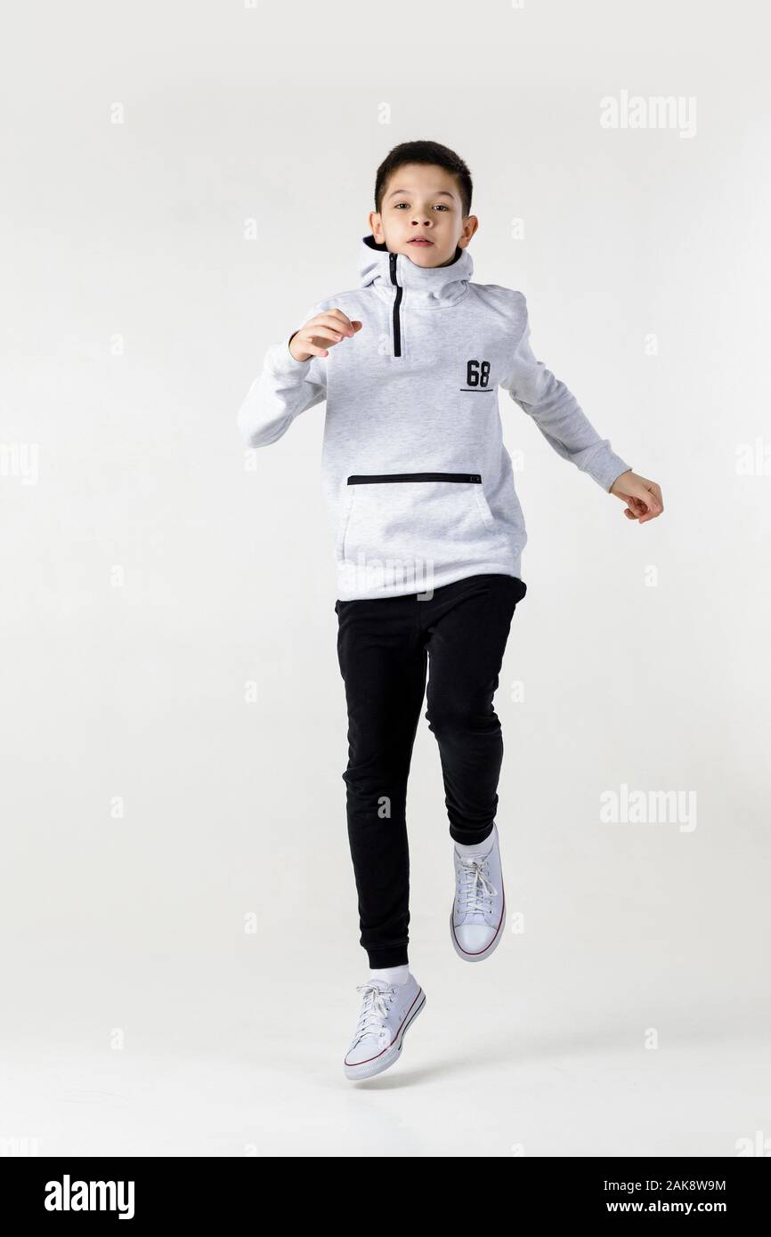 emotional little boy jumping on white studio background Stock Photo - Alamy
