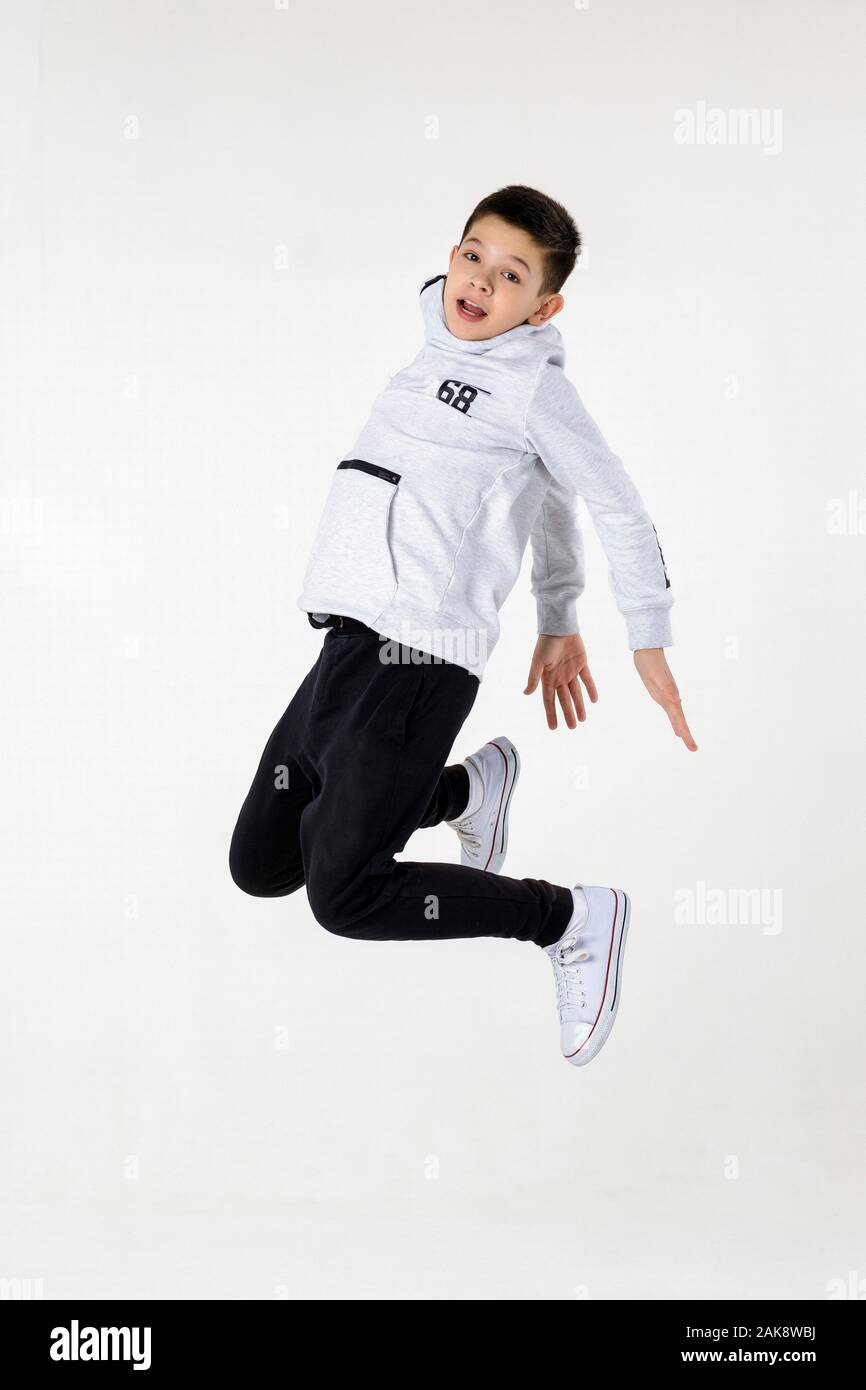emotional little boy jumping on white studio background Stock Photo - Alamy