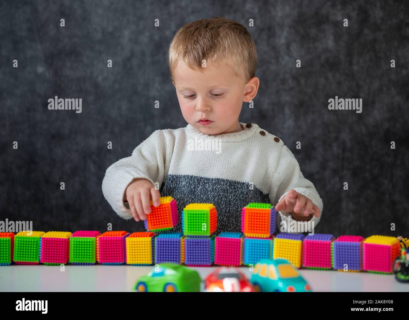 a two years old baby playing with cubes Stock Photo - Alamy