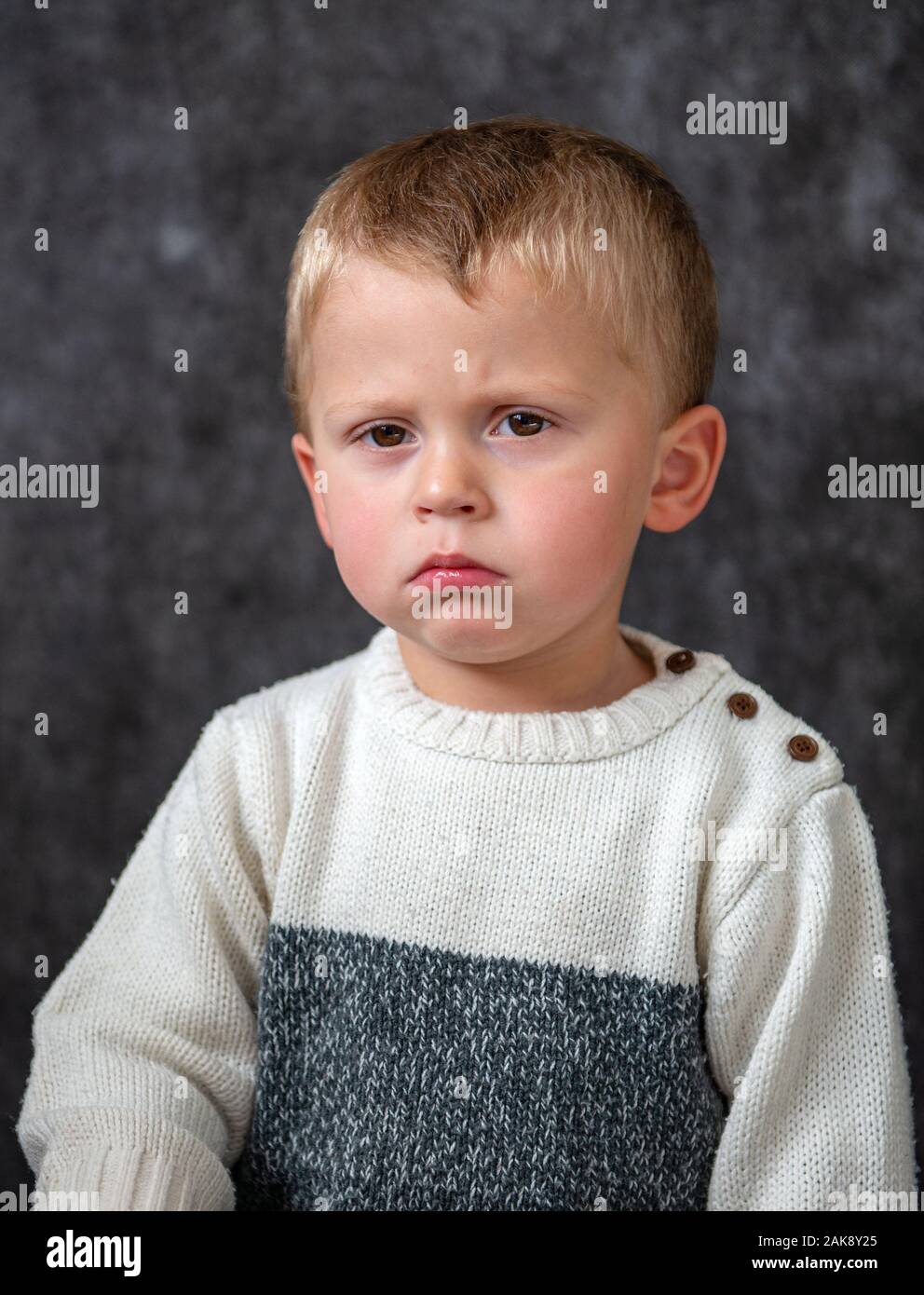 portrait of cute little boy pouting, a studio portrait Stock Photo - Alamy