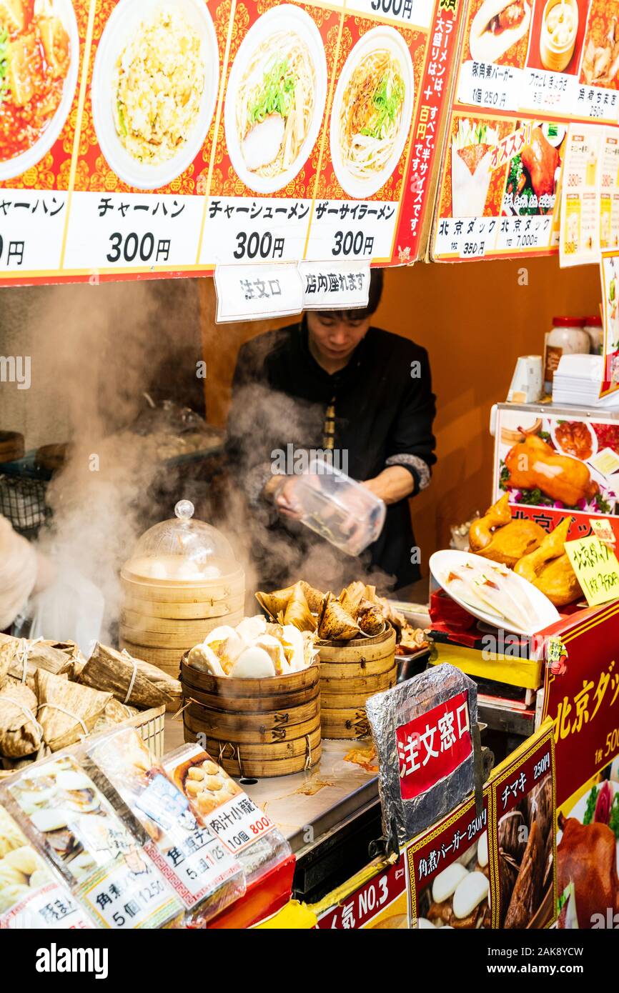 Chinatown, Nankin-Machi in Motomachi, Kobe, Japan. Man preparing food ...