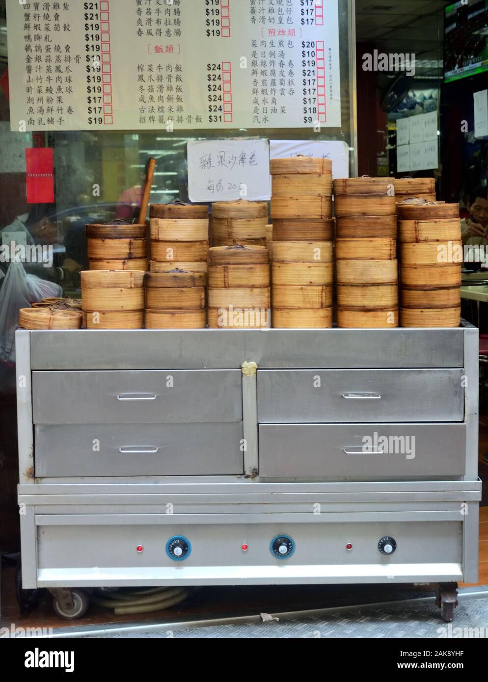 Dim sum bamboo steamers stacking up on an electric heat cart outside an ...