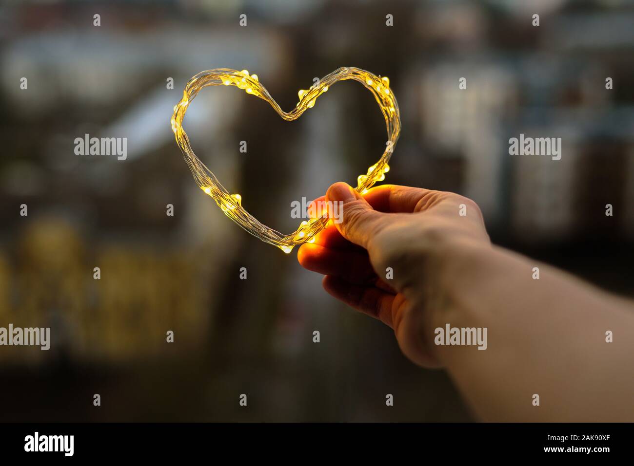 Heart made from little lights in woman hand Stock Photo - Alamy