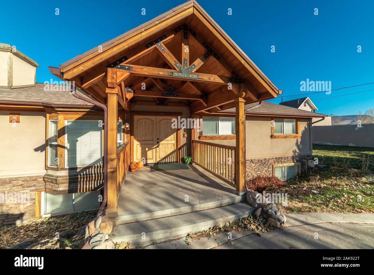 Covered wooden portico leading to a front door Stock Photo - Alamy
