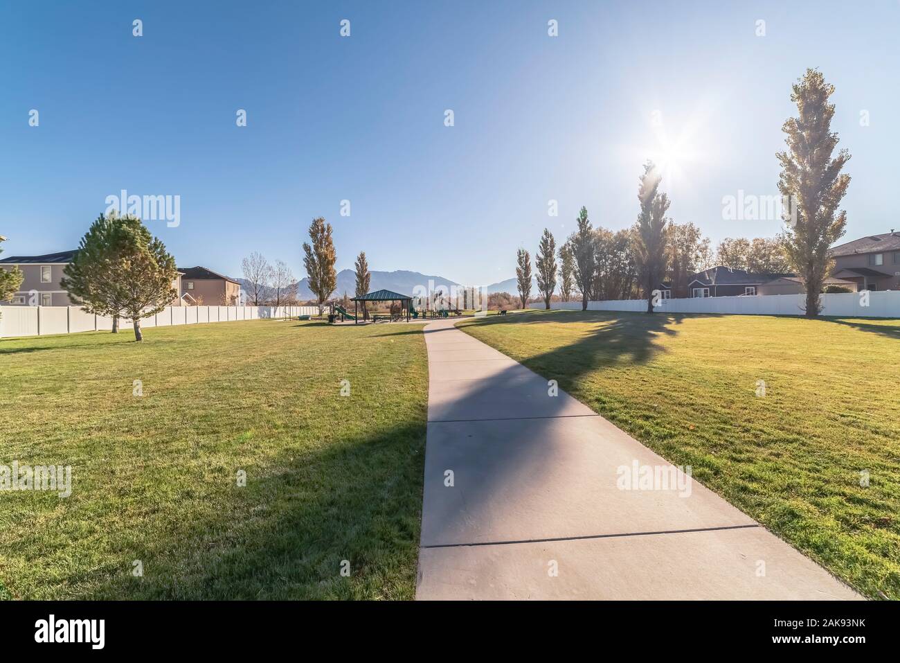 Receding empty paved pathway in a park Stock Photo - Alamy