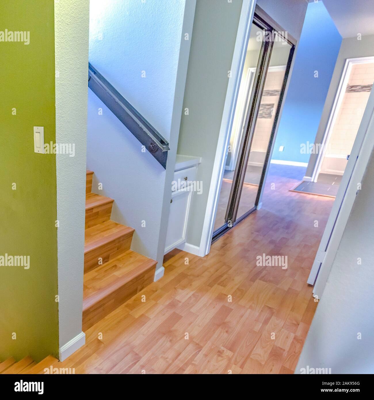 Square stairs split between a hallway indoor Stock Photo - Alamy