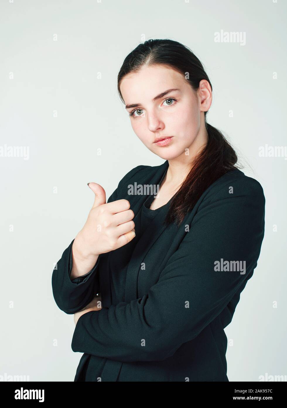 young pretty girl pointing and gesturing on white background, business ...