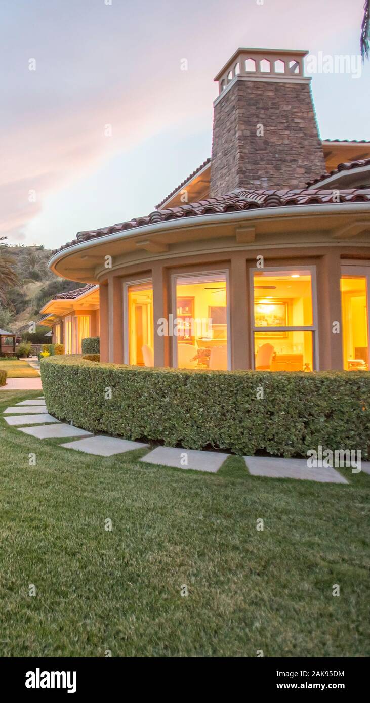 Vertical Round window display on home twilight shoot Stock Photo - Alamy