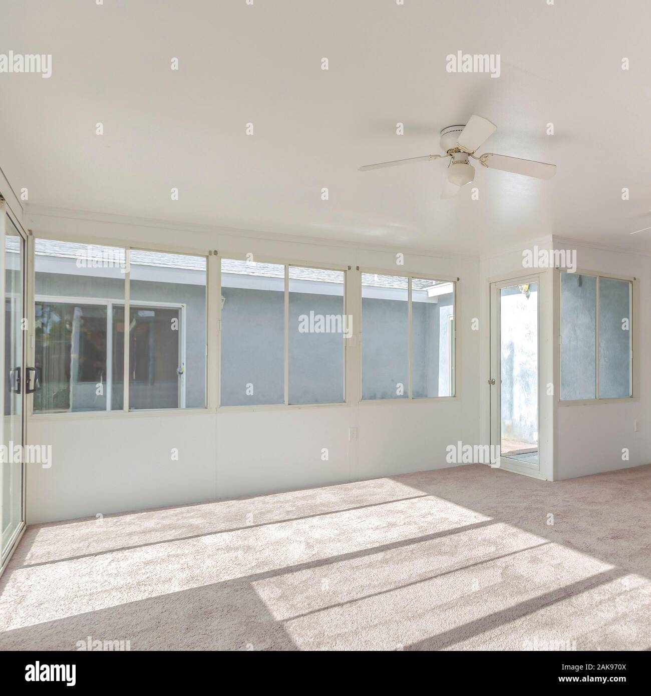 Square Bedroom with entire wall of windows Stock Photo - Alamy