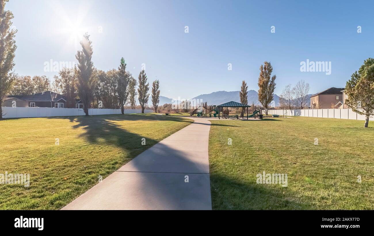 Panorama Receding empty paved pathway in a park Stock Photo - Alamy