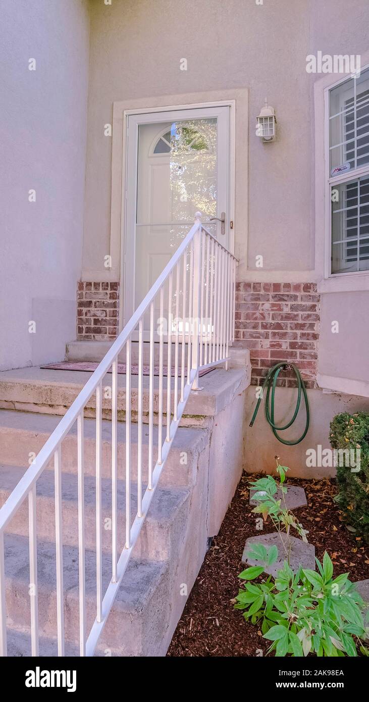 Vertical Concrete steps leading to a front door Stock Photo - Alamy