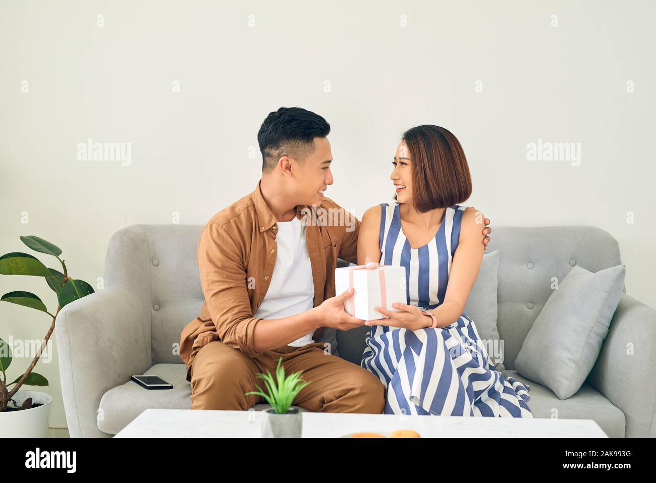 An affectionate guy giving his girlfriend at home Stock Photo - Alamy
