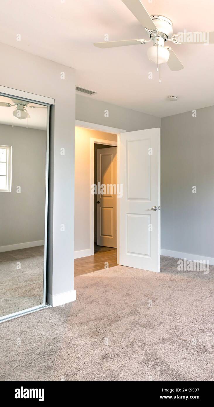 Vertical frame Empty bedroom with open door Stock Photo - Alamy
