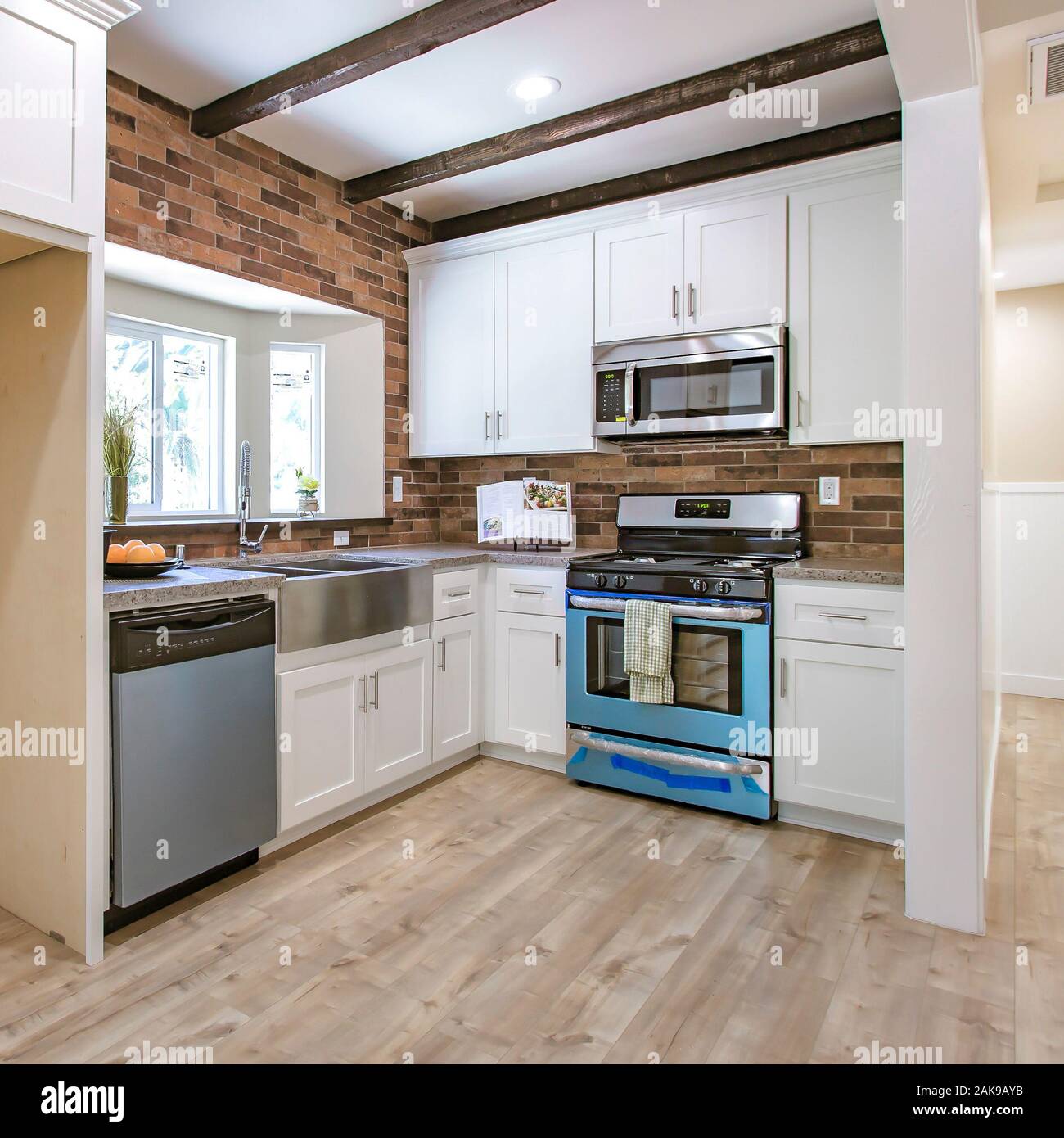 Square Kitchen with brick backsplash and counter spcae Stock Photo - Alamy