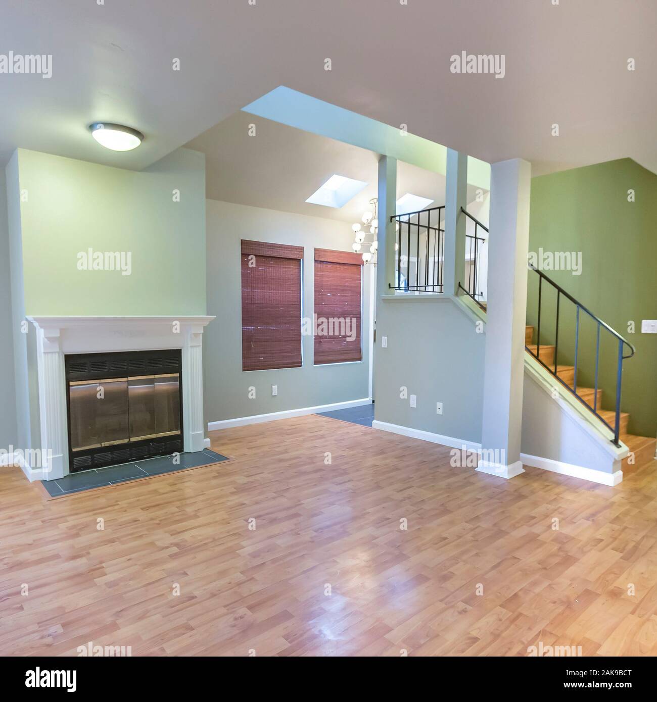 Square frame Fireplace by stairs in empty townhome Stock Photo - Alamy
