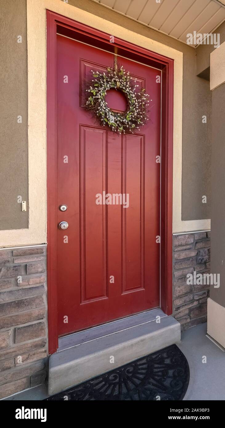 Vertical Colourful red entrance door with wreath near sunset Stock ...