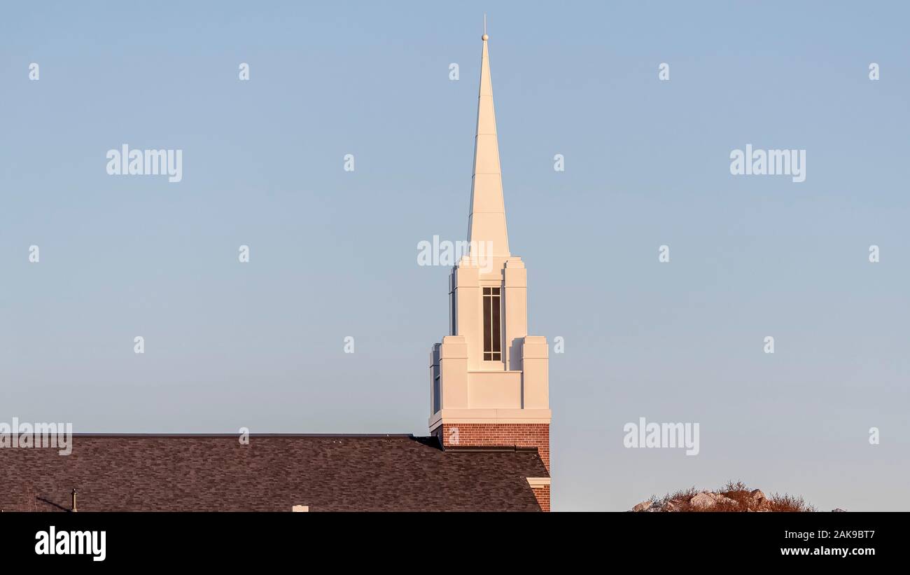 Panorama frame Small modern church with white steeple near sunrise ...