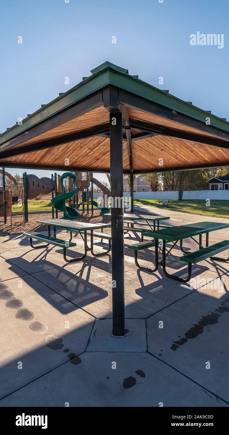 Vertical Outdoors covered tables and benches for a picnic Stock Photo ...