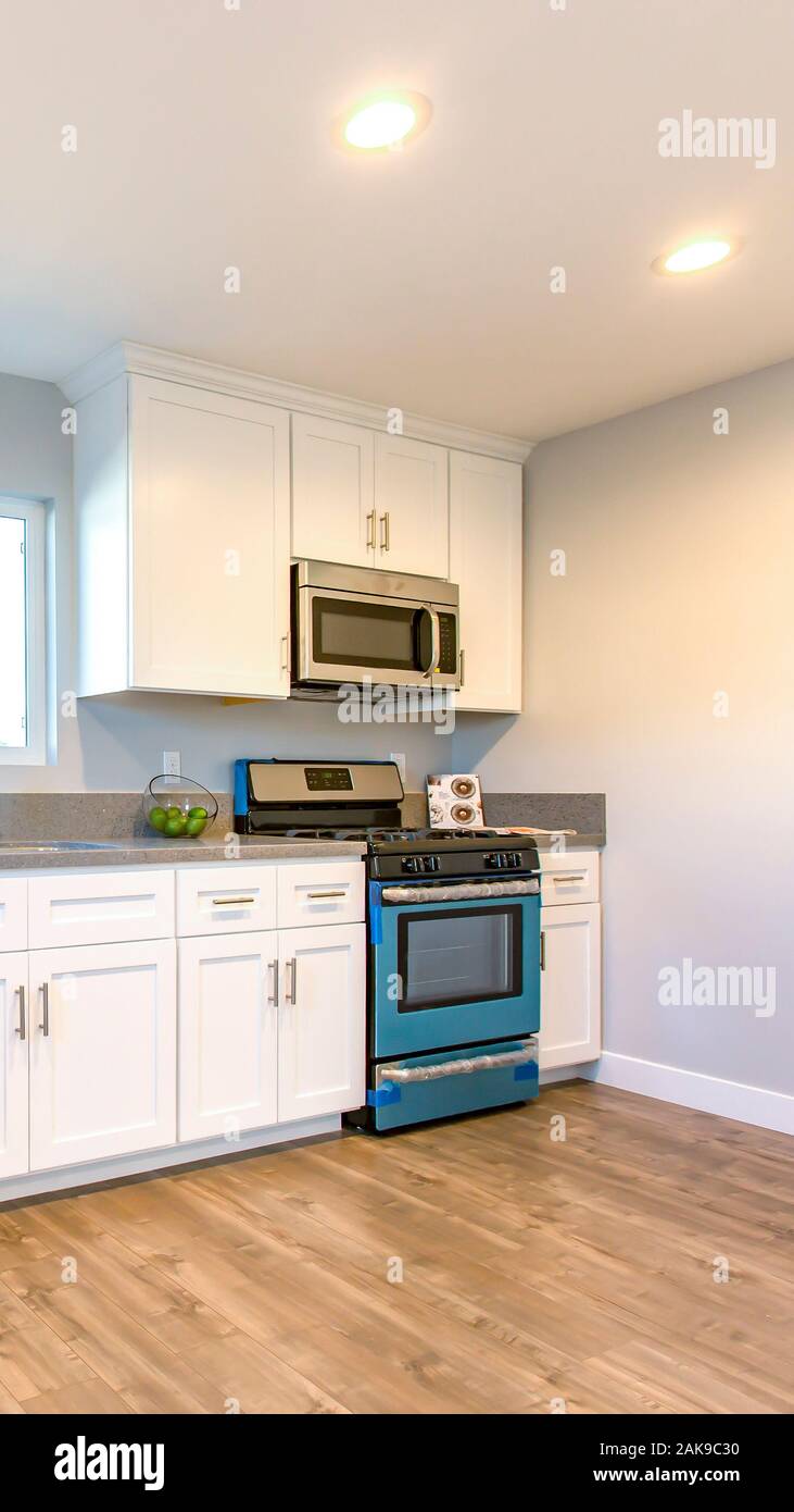 Vertical frame Kitchen with wood floors and single wall Stock Photo - Alamy