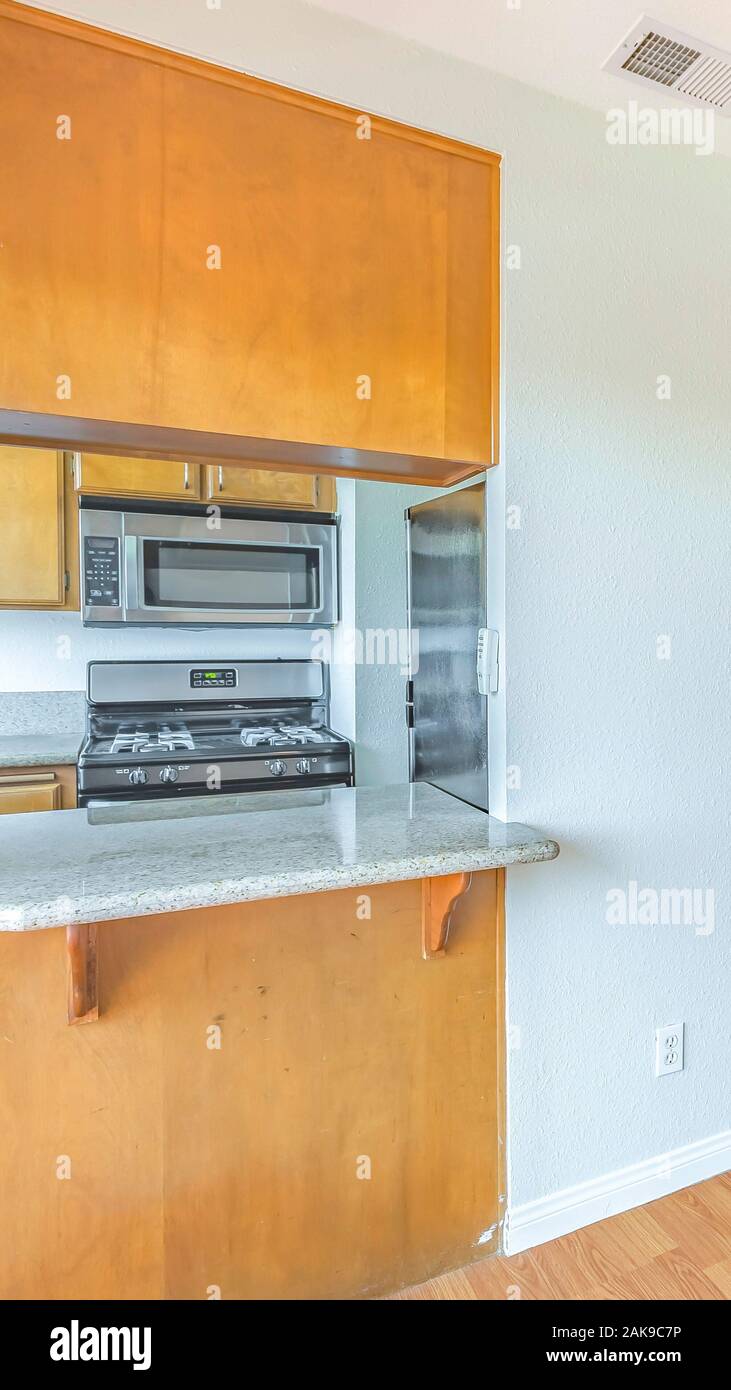 Vertical Kitchen with a view of living room Stock Photo - Alamy
