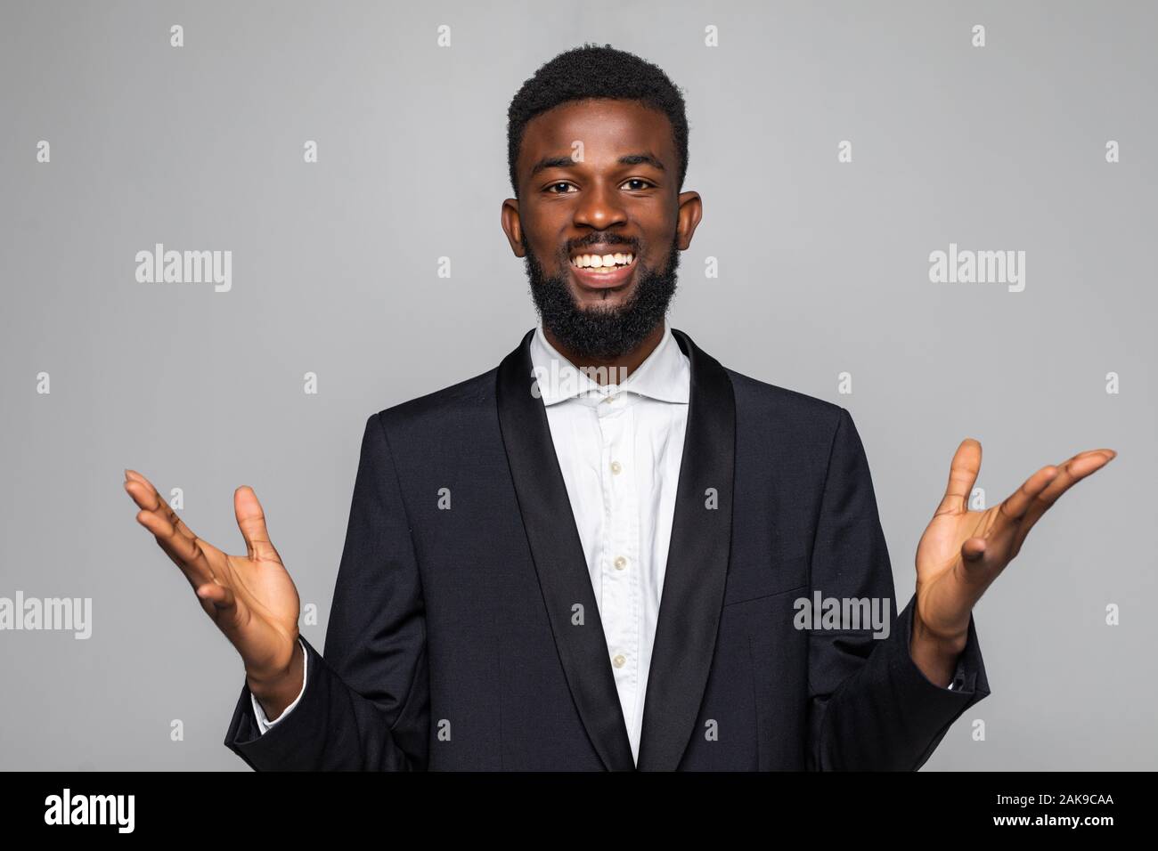A handsome tall African American man standing in a suit with ...
