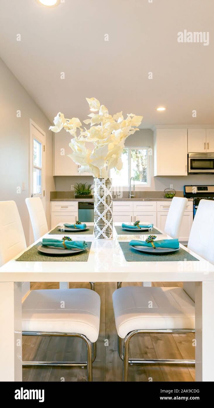 Vertical frame Kitchen table with all chairs pushed in Stock Photo - Alamy