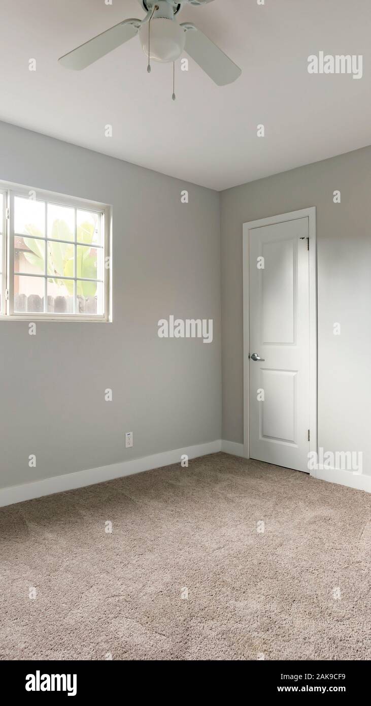 Vertical frame Empty bedroom with open door to hallway Stock Photo - Alamy