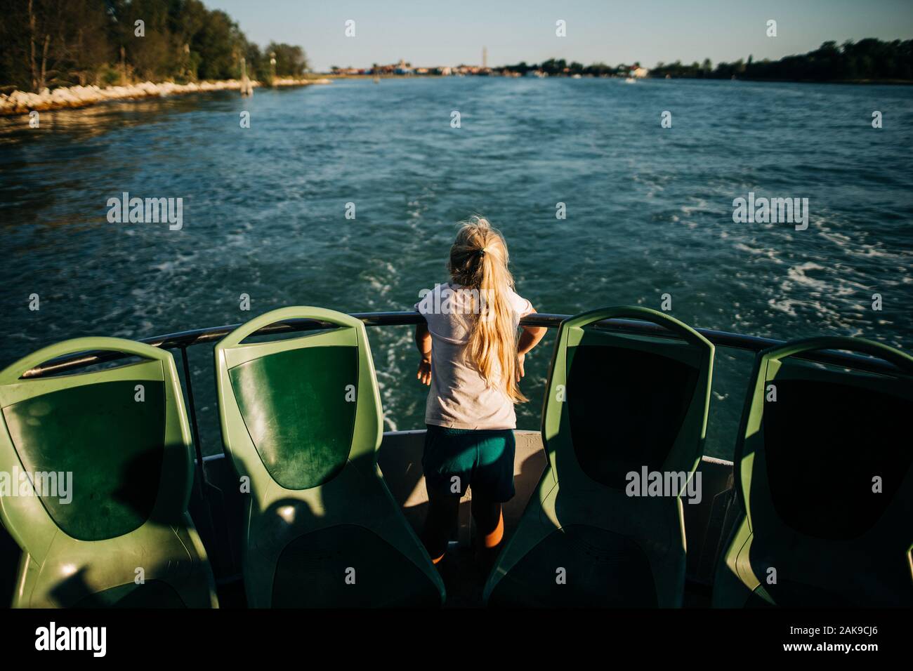 girl with white hair on a boat in italy looks at the sea Stock Photo ...