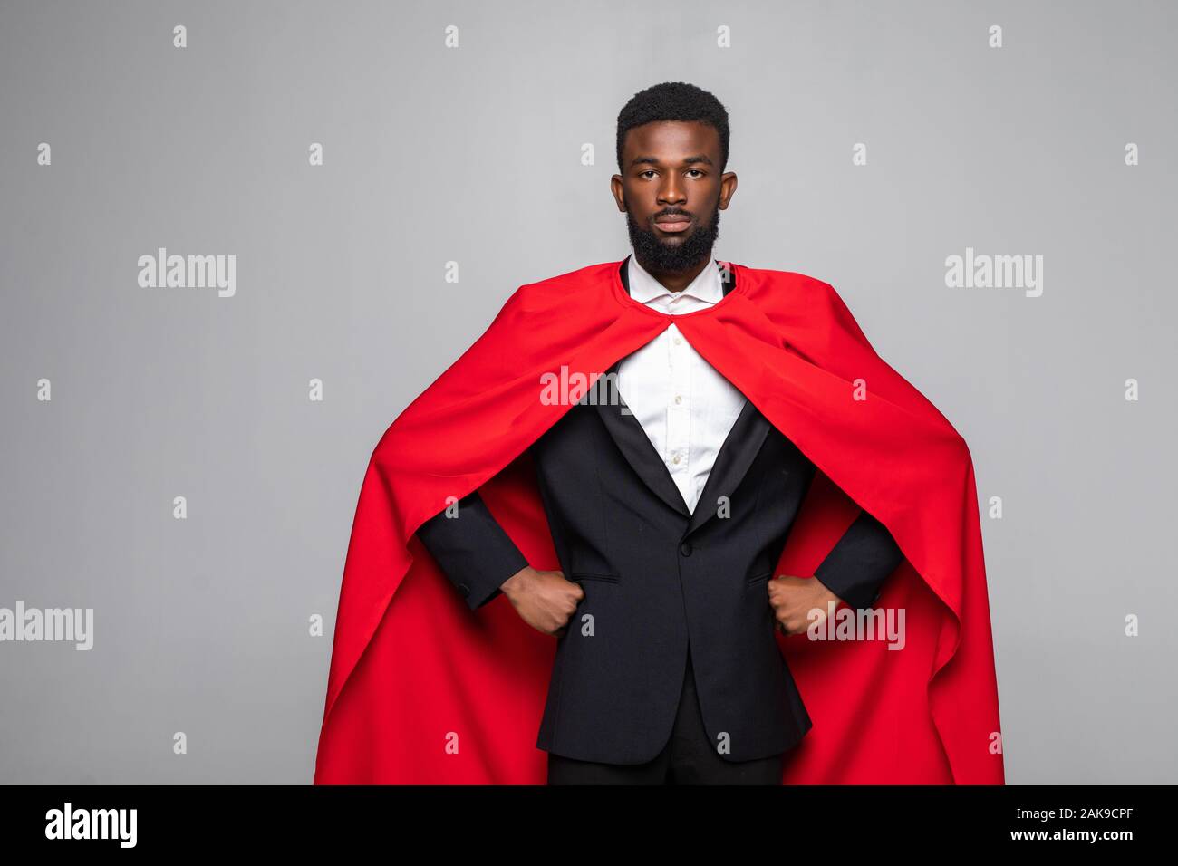 African businessman superman on gray background Stock Photo - Alamy