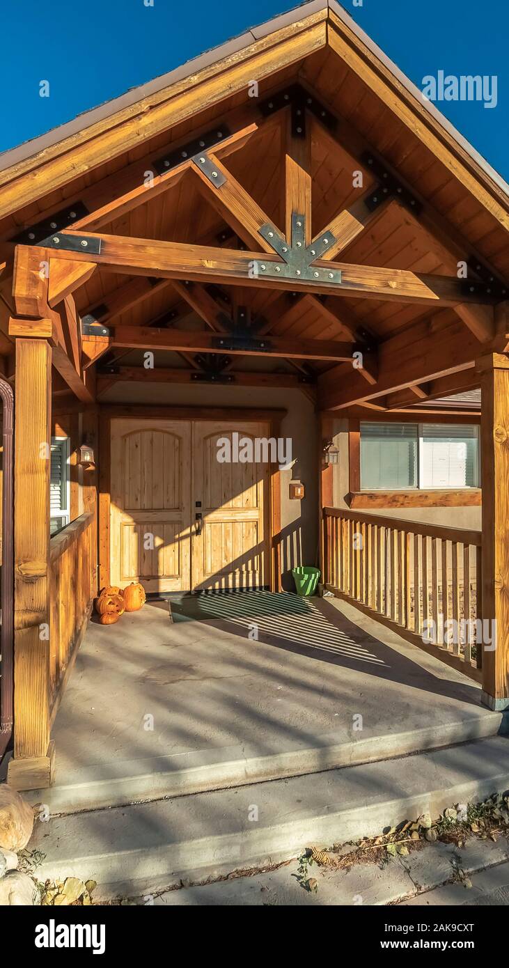 Vertical Covered wooden portico leading to a front door Stock Photo - Alamy