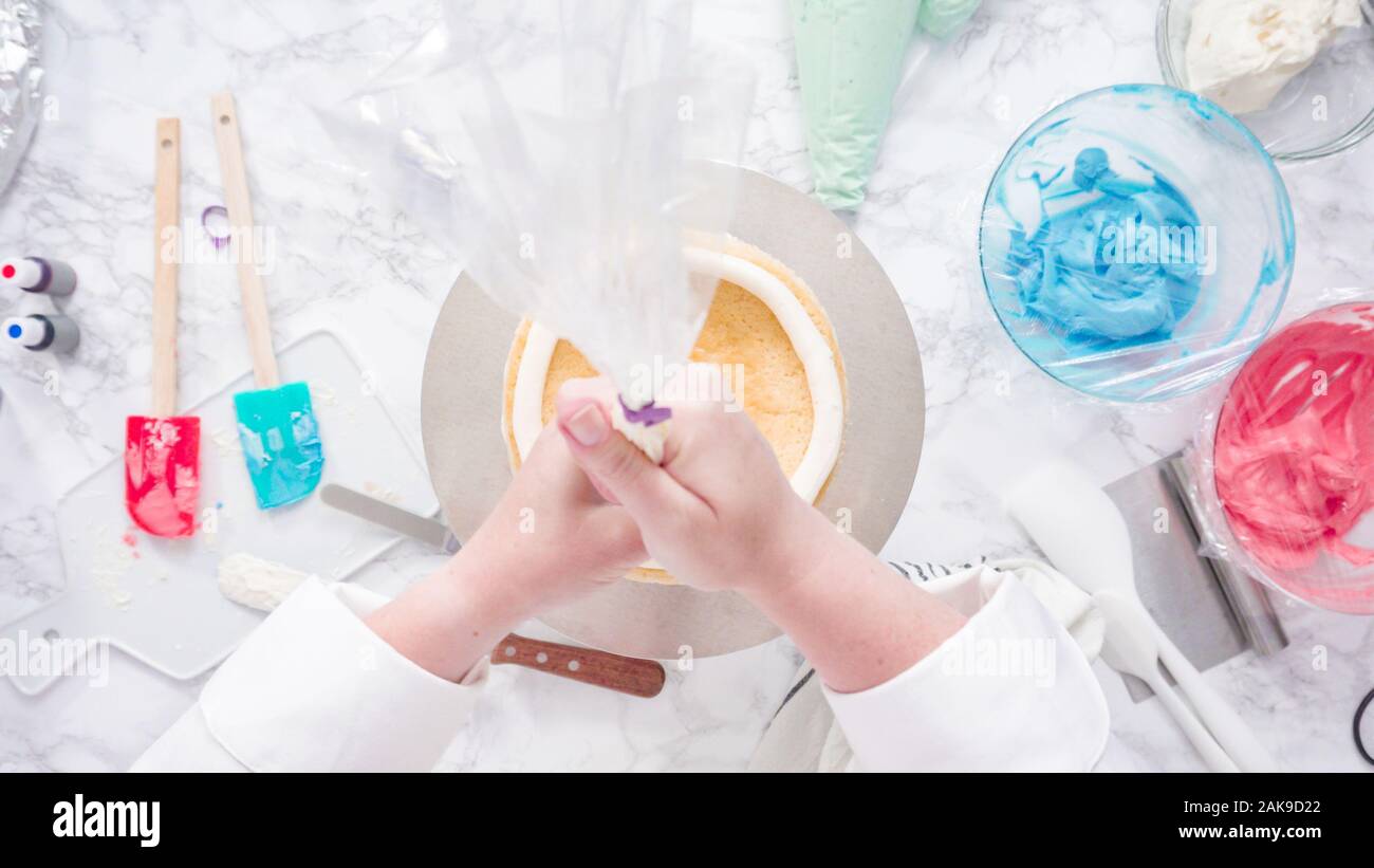 Stacking cake layers to create the round three-layer vanilla cake Stock ...