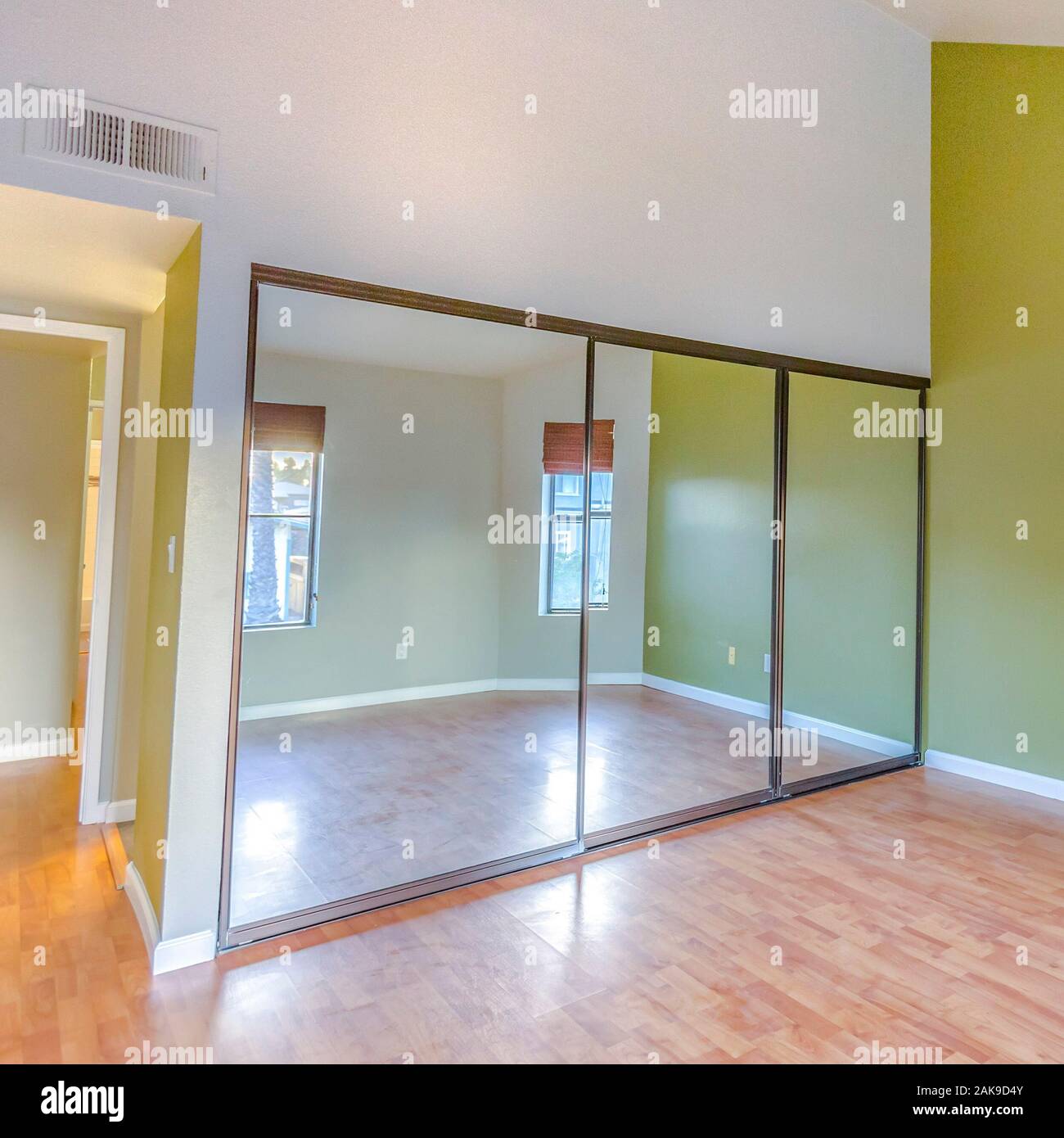 Square Empty master bedroom with wood floor Stock Photo - Alamy