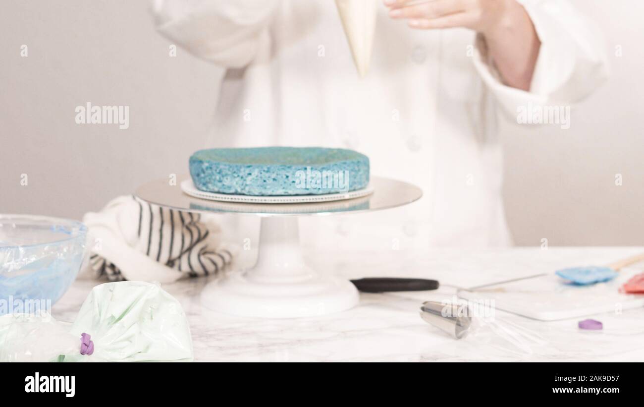 Stacking cake layers to create the round three-layer vanilla cake Stock ...