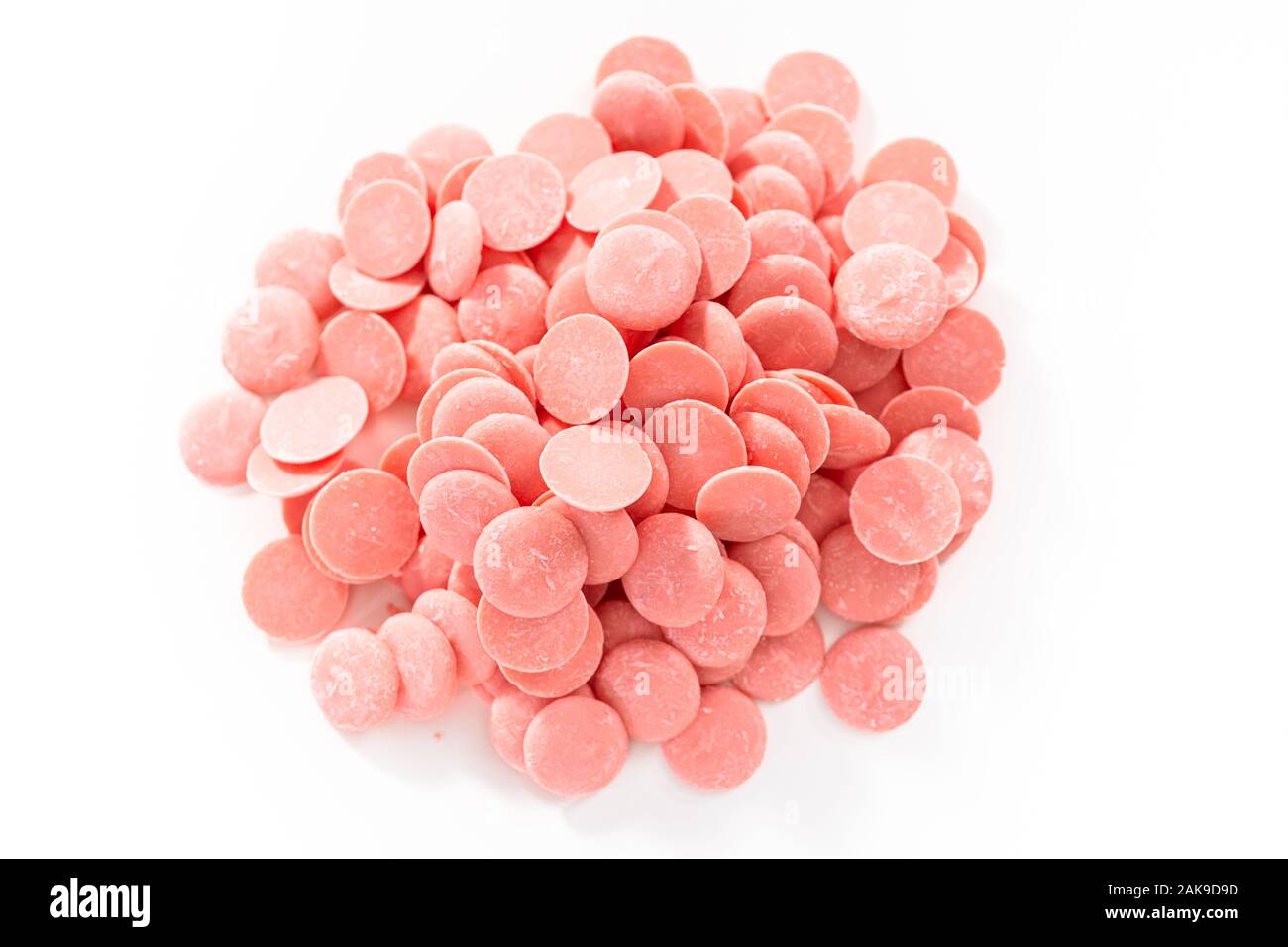 Pink round chocolate chips for melting chocolate shapes on a white ...