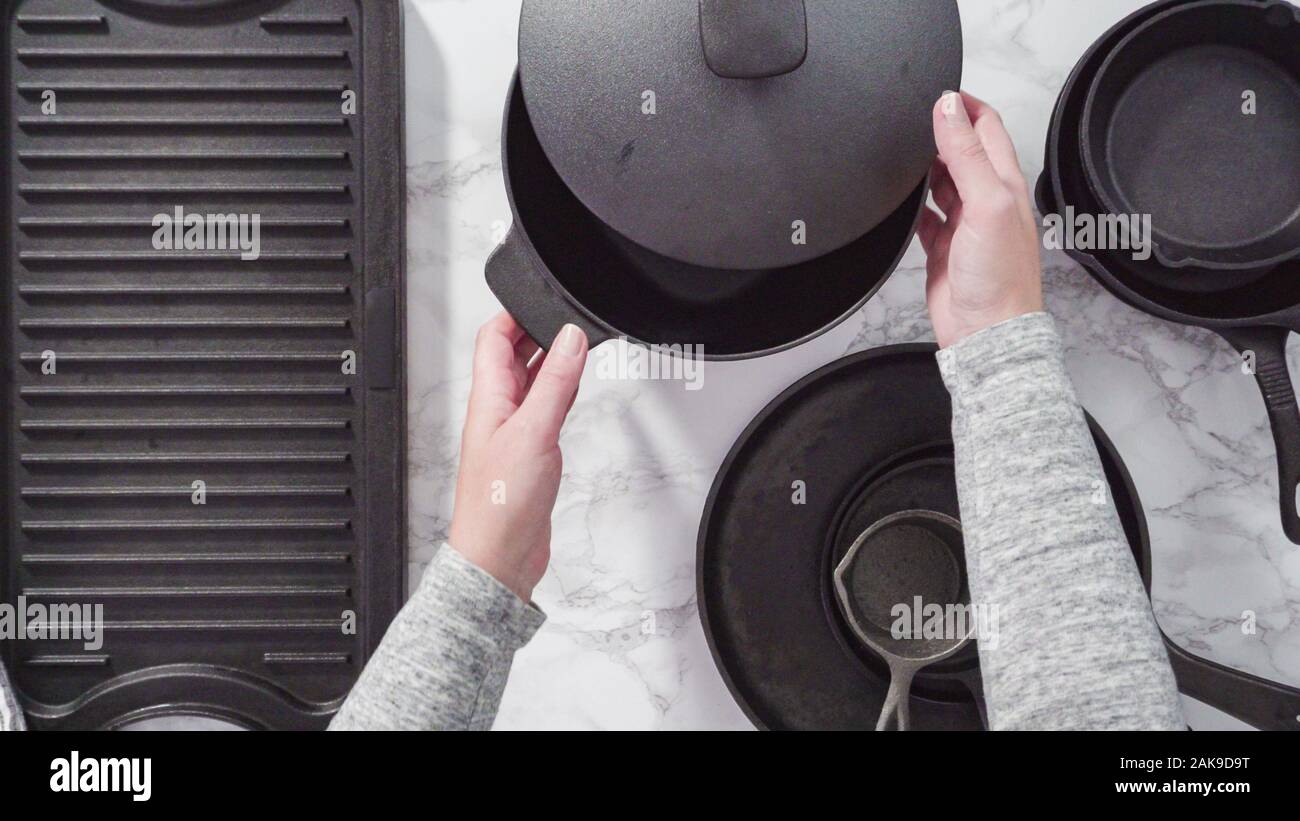 Flat lay. Variety of cast iron kitchenware on a marble countertop Stock ...