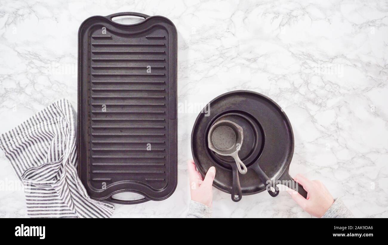 Flat lay. Variety of cast iron kitchenware on a marble countertop Stock ...