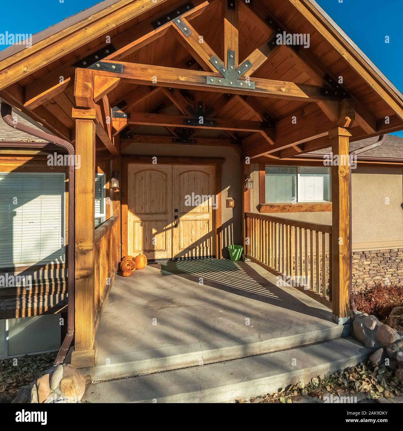 Square frame Covered wooden portico leading to a front door Stock Photo ...