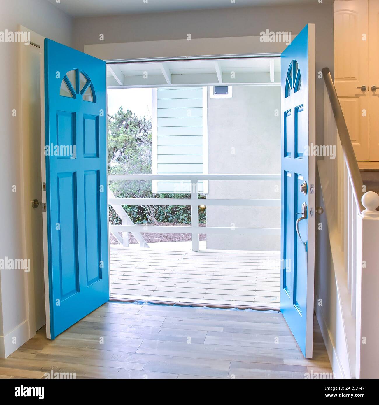 Square frame Wide open front doors with townhome Stock Photo - Alamy