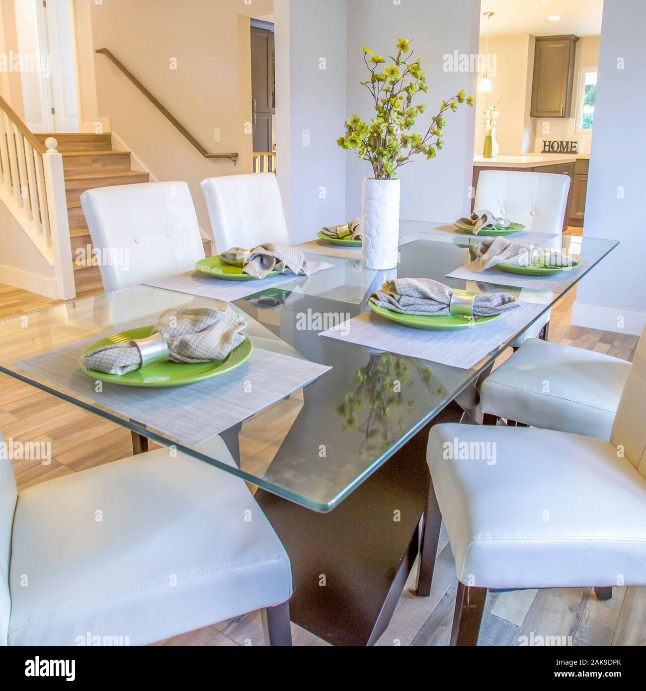 Square Kitchen table in decorated model home Stock Photo - Alamy