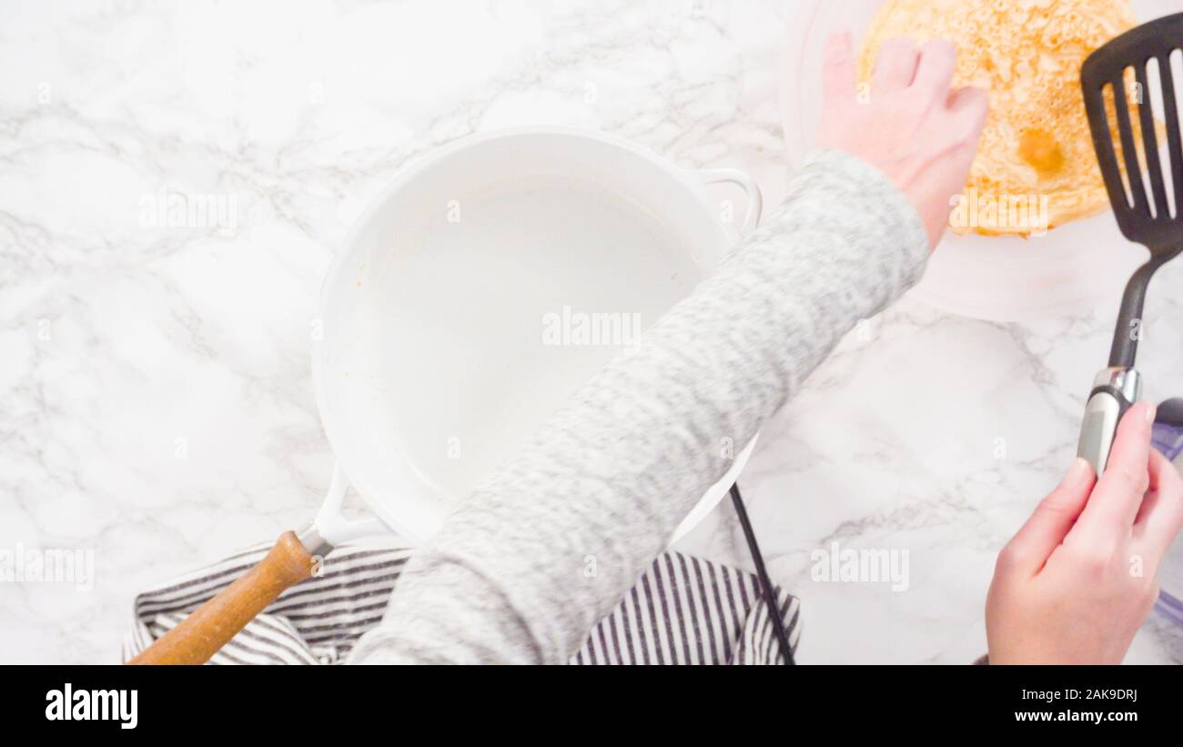 Flat lay. Making crepes in a small frying pan over medium heat Stock ...