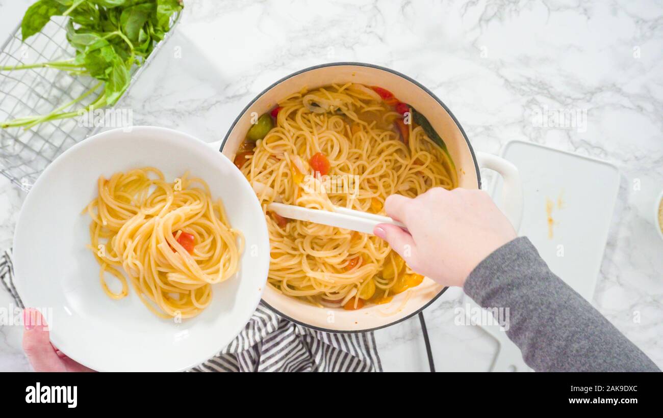 Flat lay. Step by step. Serving a one-pot pasta into a white pasta ...
