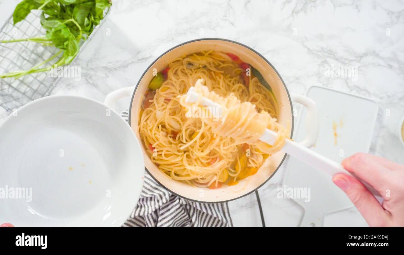 Flat lay. Step by step. Serving a one-pot pasta into a white pasta ...