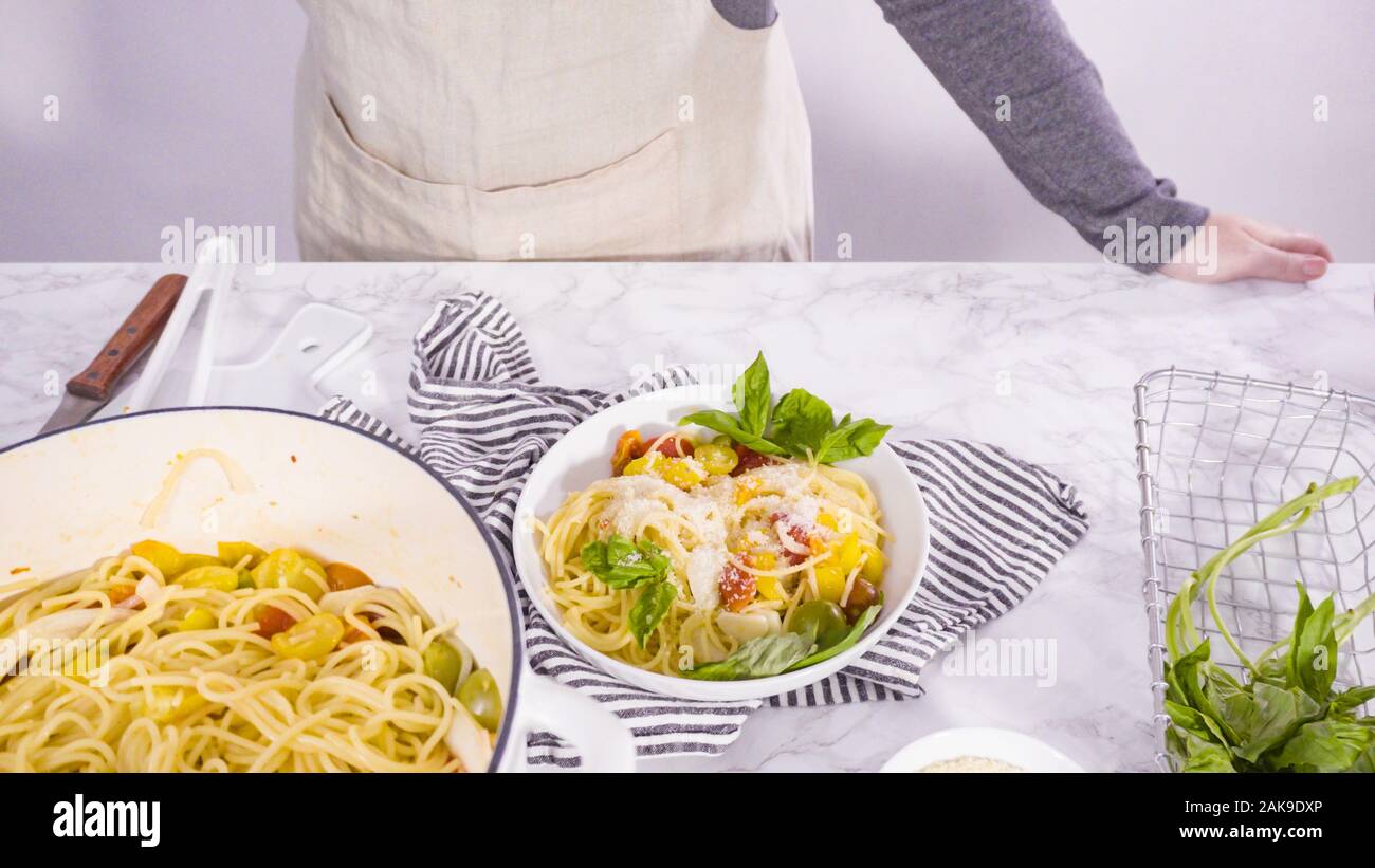 Step by step. Serving a one-pot pasta into a white pasta plate Stock ...