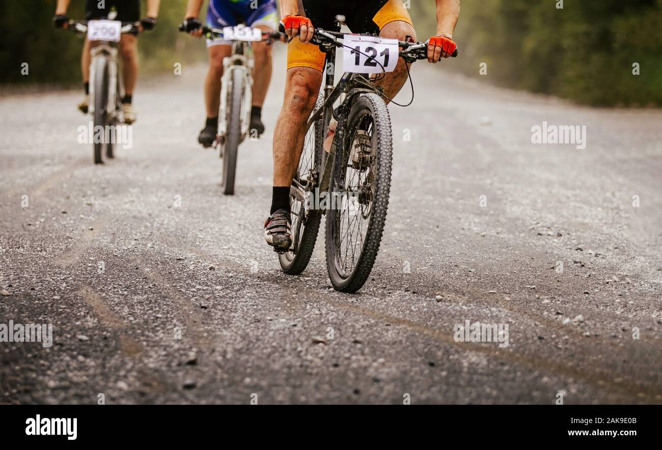 three cyclists riders on mountain bikes riding during bike race Stock ...
