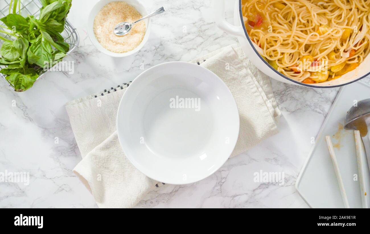 Flat lay. Step by step. Serving a one-pot pasta into a white pasta ...