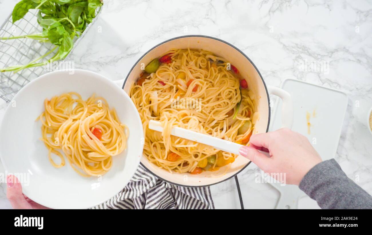 Flat lay. Step by step. Serving a one-pot pasta into a white pasta ...