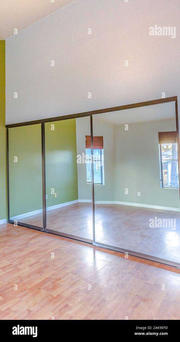 Vertical frame Empty master bedroom with wood floor Stock Photo - Alamy