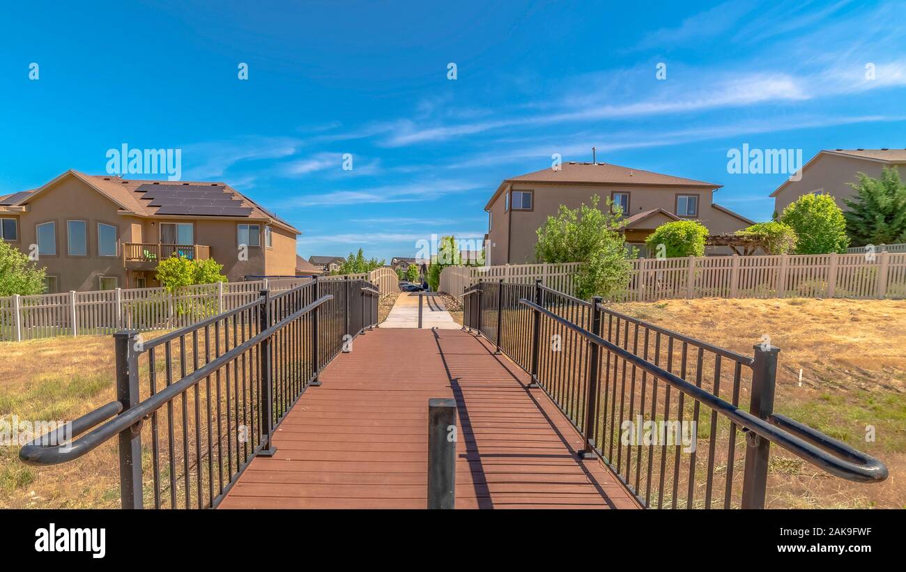 Pano frame Sunny day view of bridge with brown deck and metal handrails ...