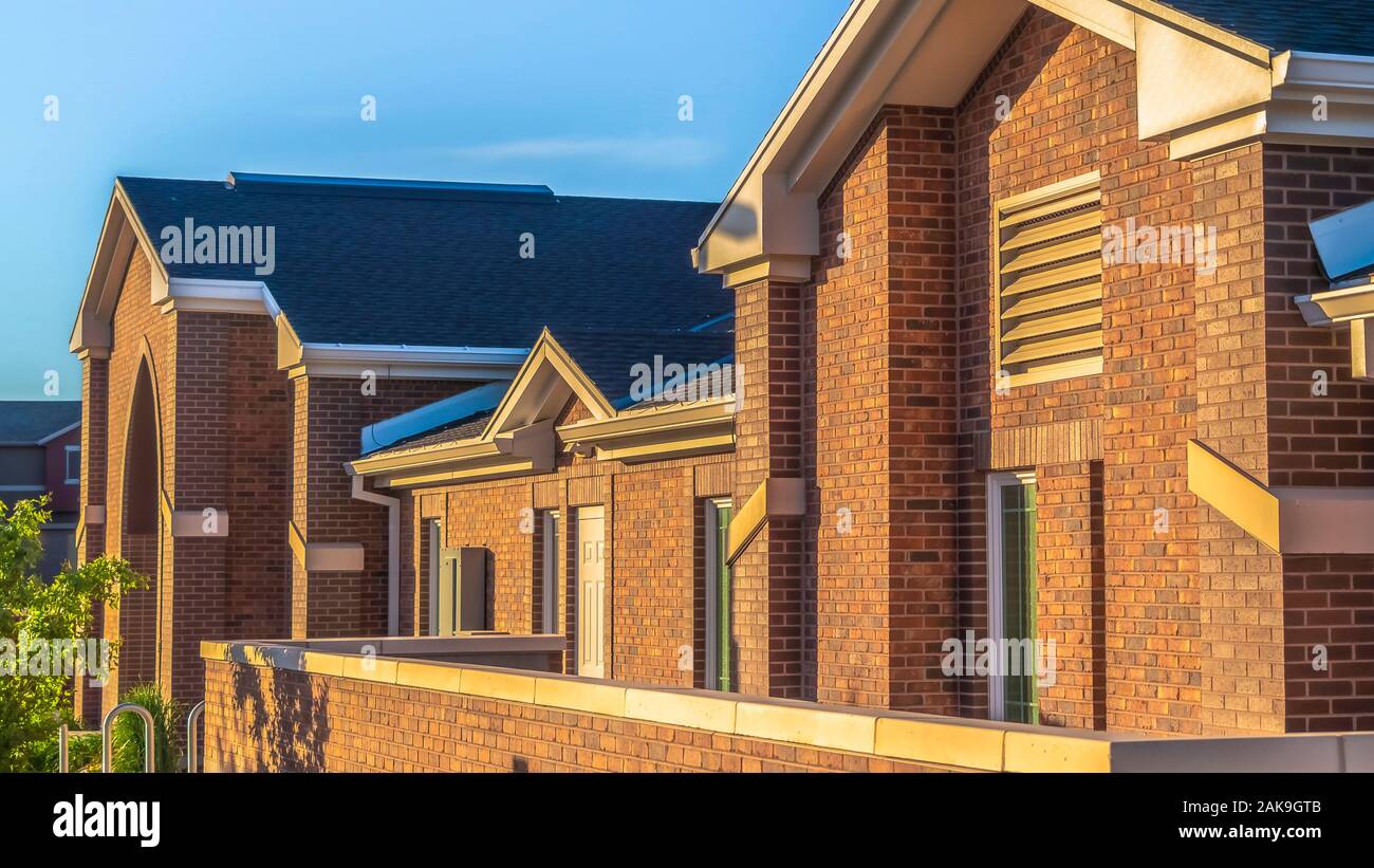 Pano frame Church exterior with red brick wall and shingles on the roof ...