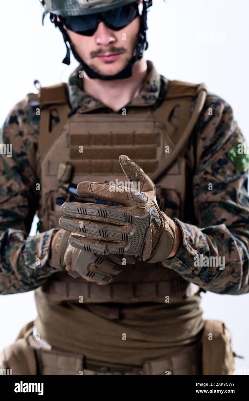 closeup of modern warfare soldier hands putting protective battle ...
